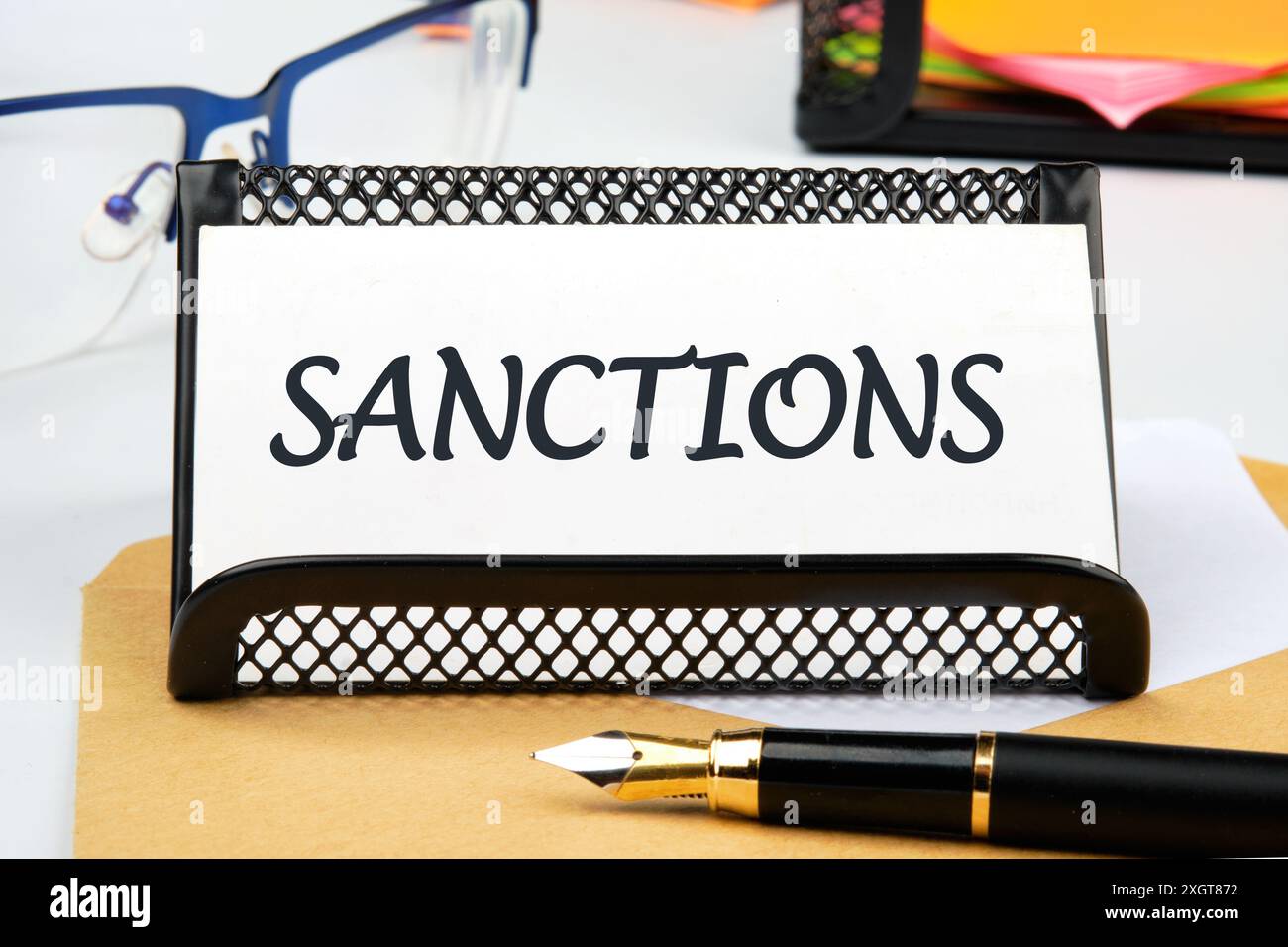 SANCTIONS word. text on a business card in a black stand Stock Photo ...