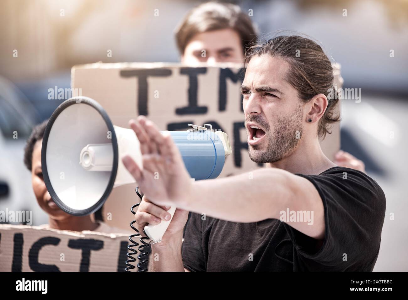 Frustrated man, megaphone and protest with community for human rights ...