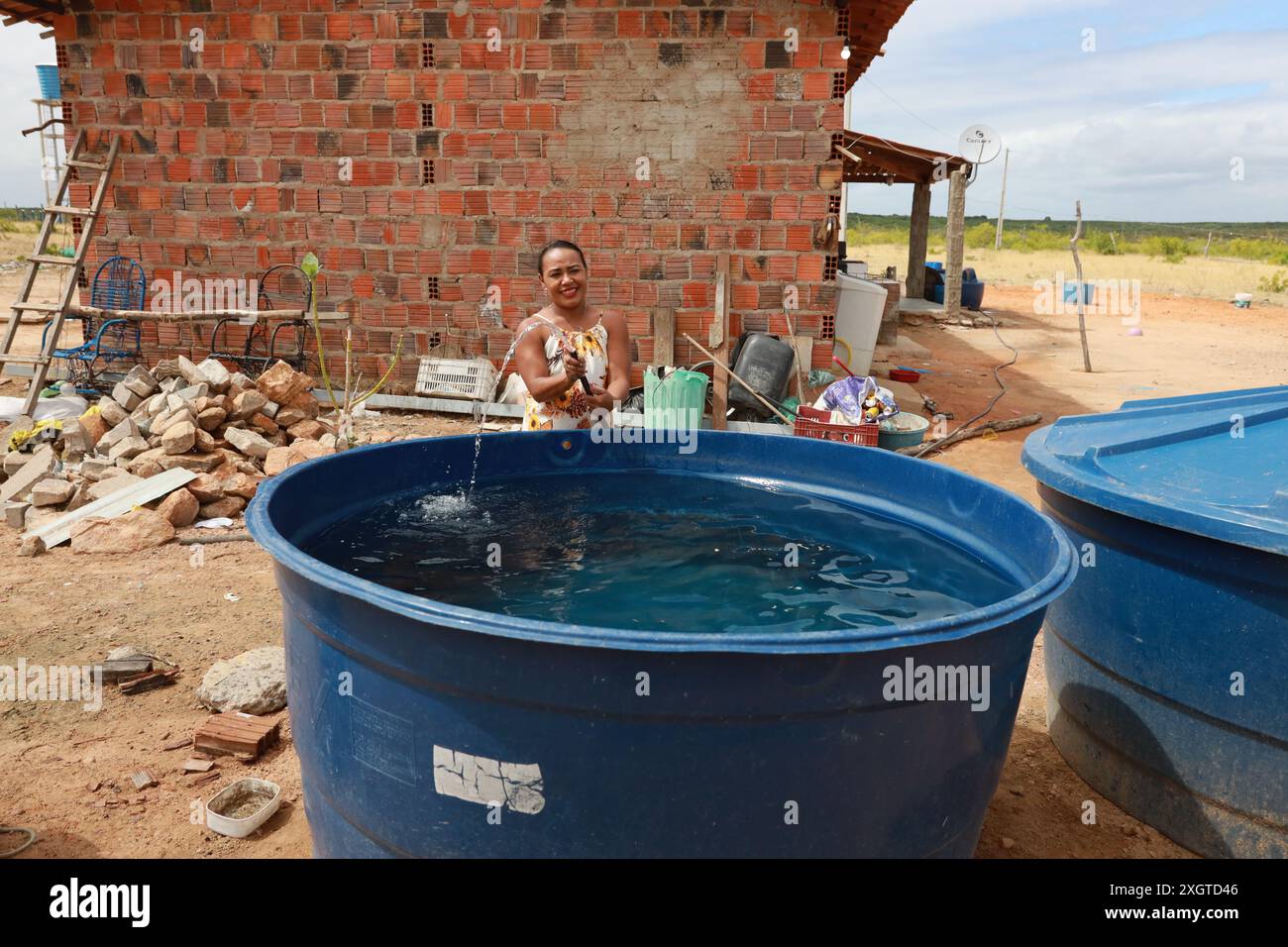 Woman collects water in tank hi-res stock photography and images - Alamy
