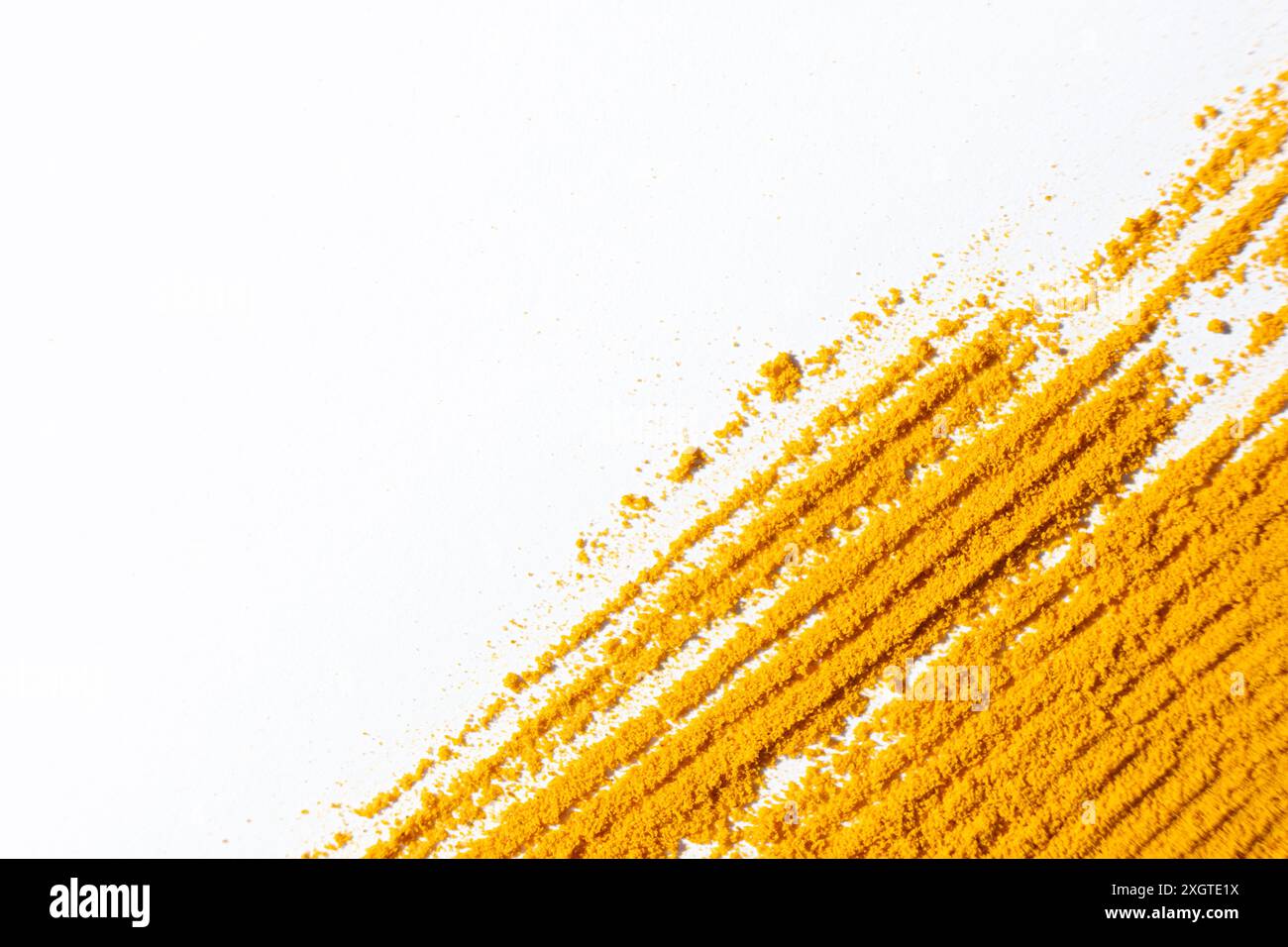 Abstract striped orange background of spilled turmeric on white ...