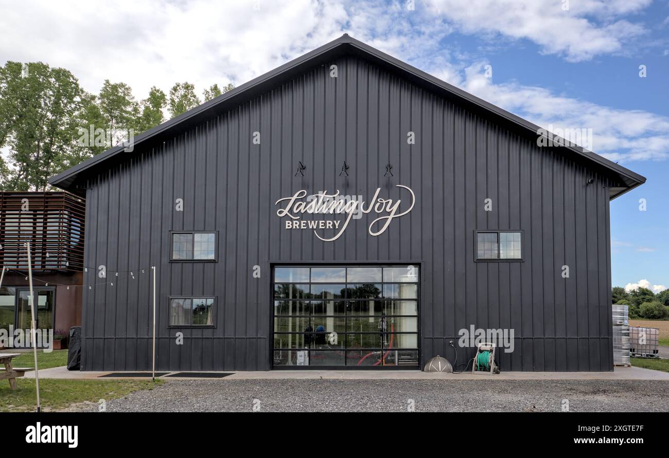 Tivoli, NY, USA - May 29, 2024: Lasting Joy Brewery logo sign near barn ...