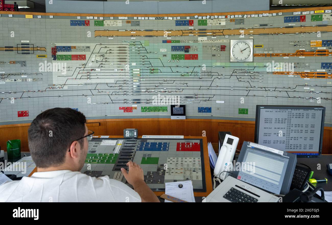 10 July 2024, Bavaria, Donauwörth: A dispatcher sits in the station in ...
