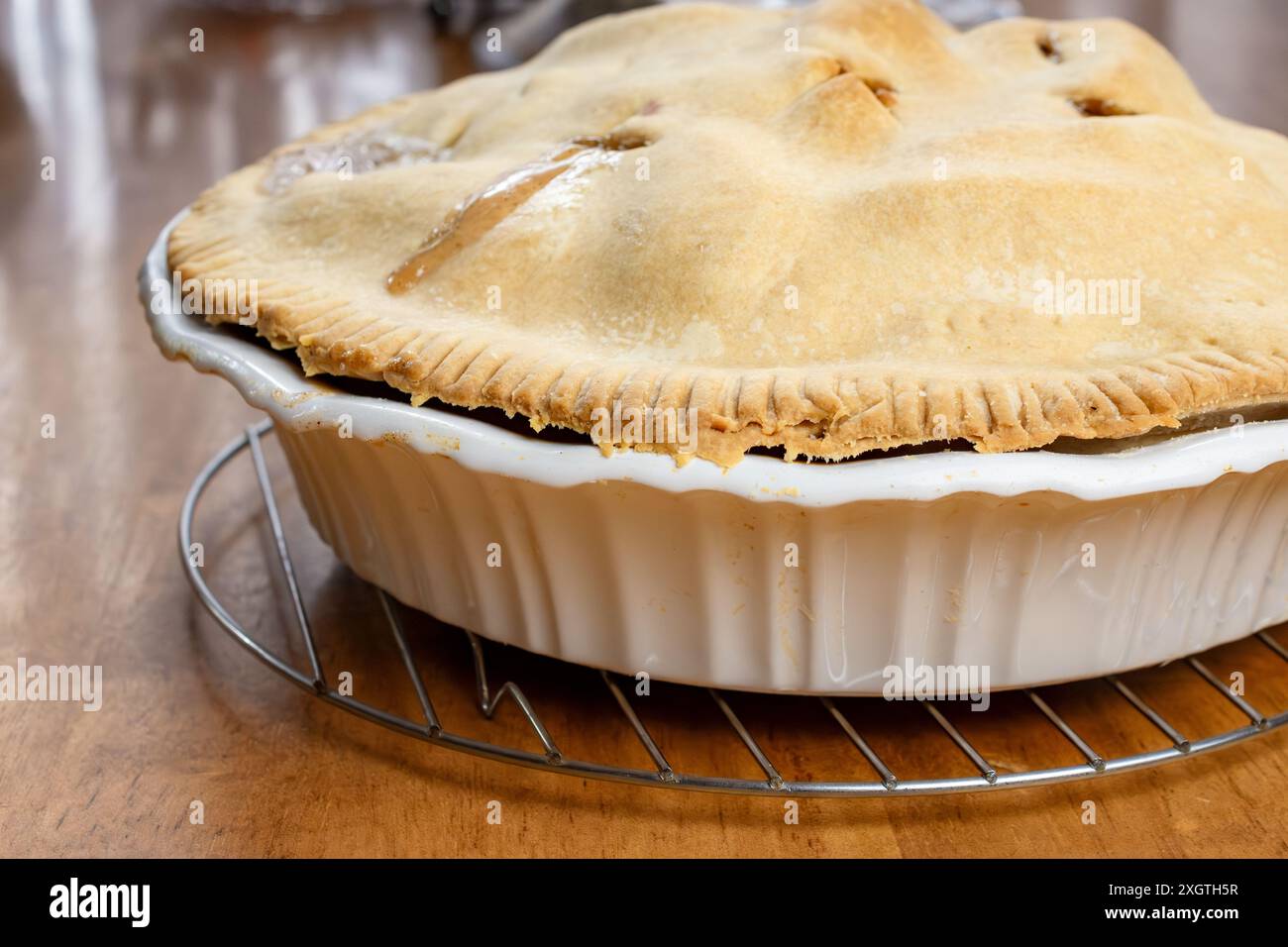 Making a pie: Completed pie on the wooden table Stock Photo - Alamy