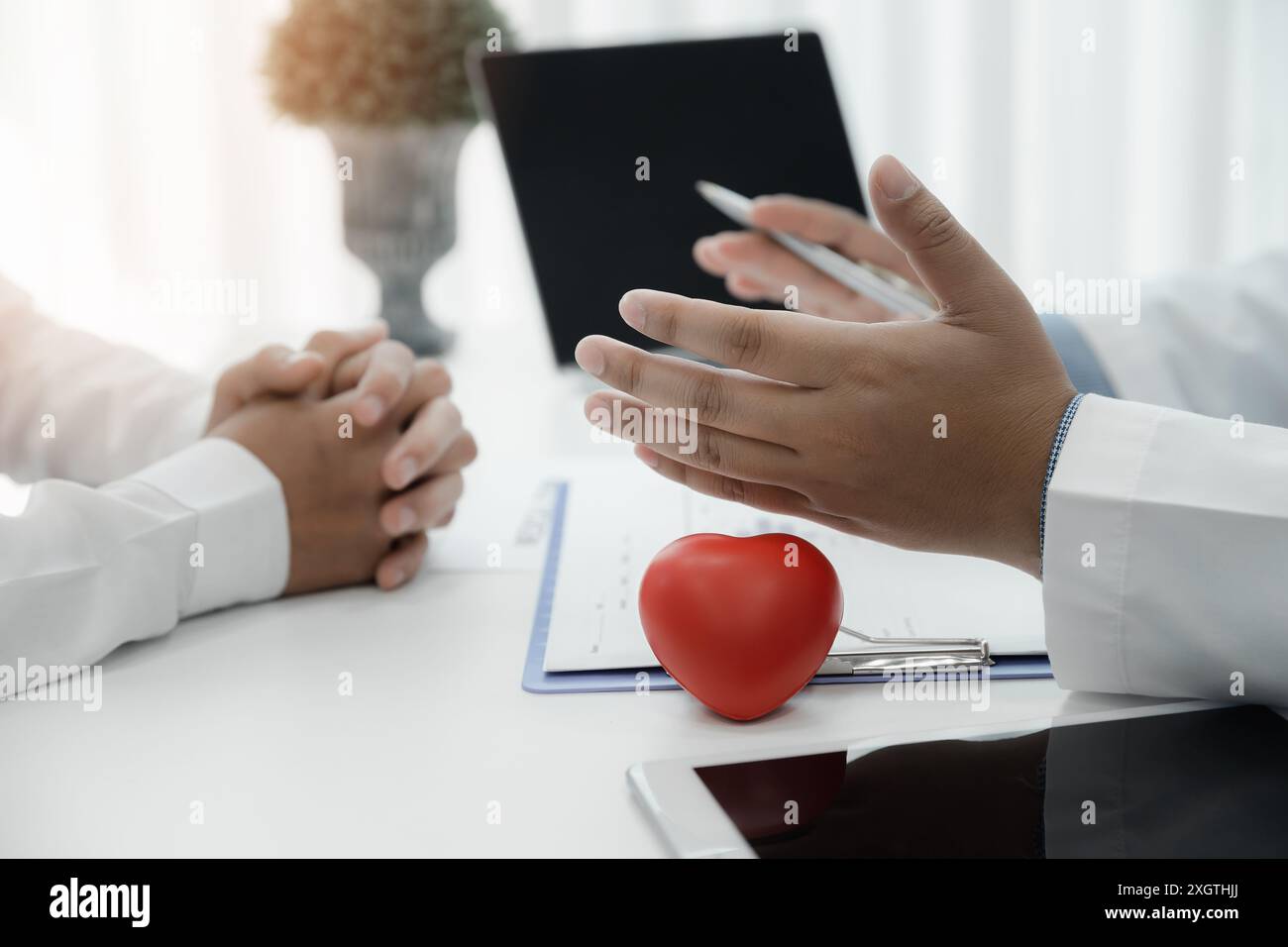 Doctor explaining heart to patient about details and risks operation ...
