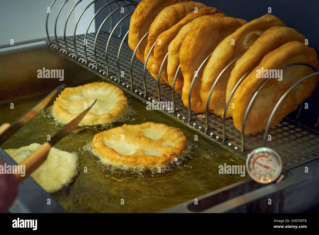 Langos, a typical Hungarian food. Deep fried flatbread in oil Stock ...