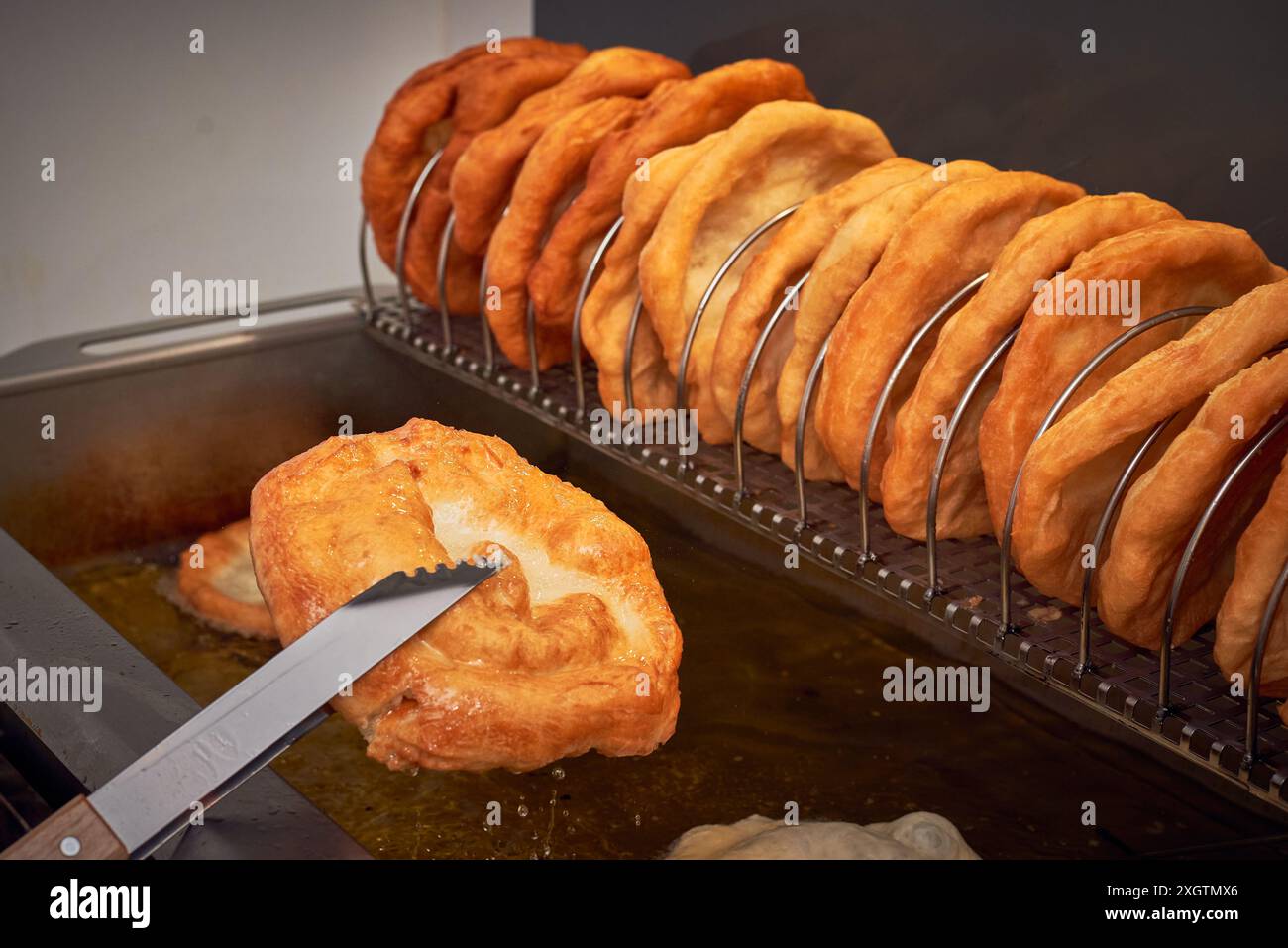 Langos, a typical Hungarian food. Deep fried flatbread in oil Stock ...