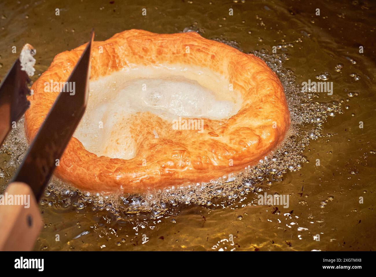 Langos, a typical Hungarian food. Deep fried flatbread in oil Stock ...