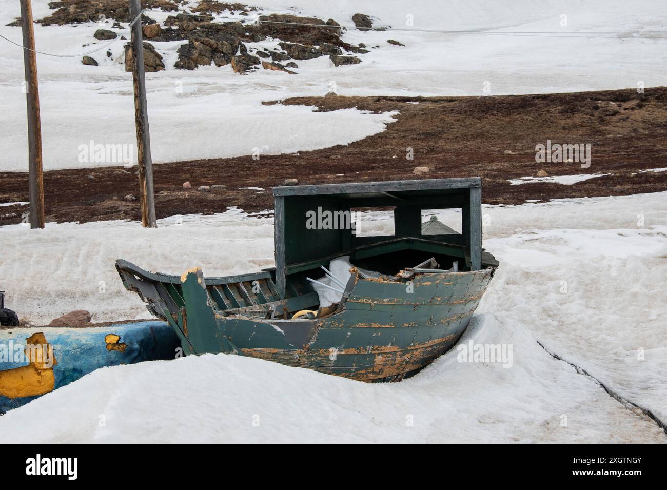 Green wooden boat stored on Red Boat Beach in Apex, Nunavut, Canada ...