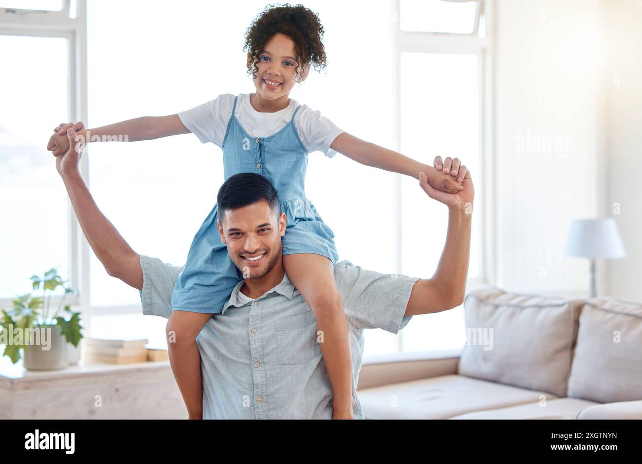 Portrait, dad and girl on shoulders in home for playful game, interaction and bonding for ...