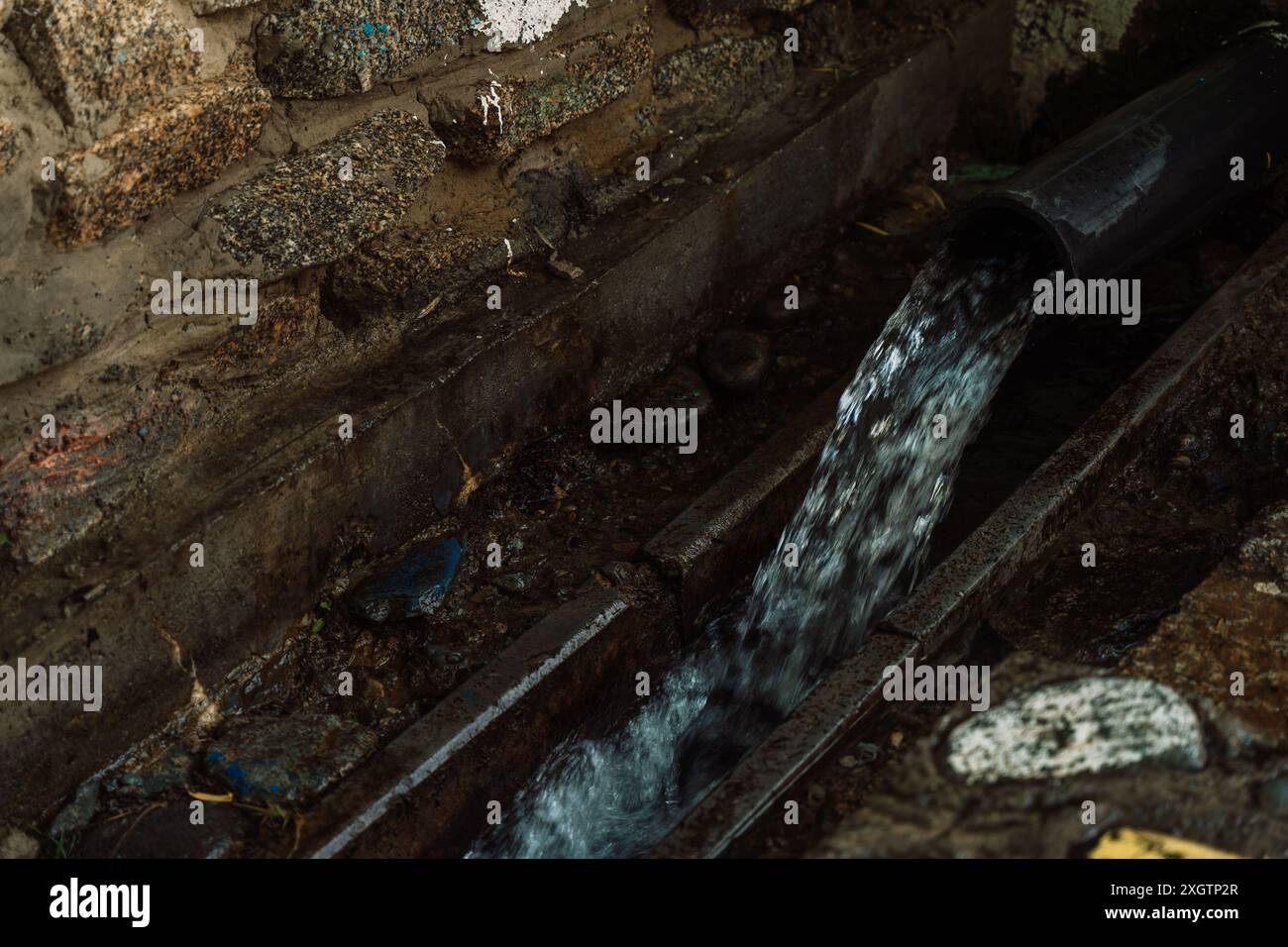 Pure spring water flows from an iron pipe Stock Photo - Alamy