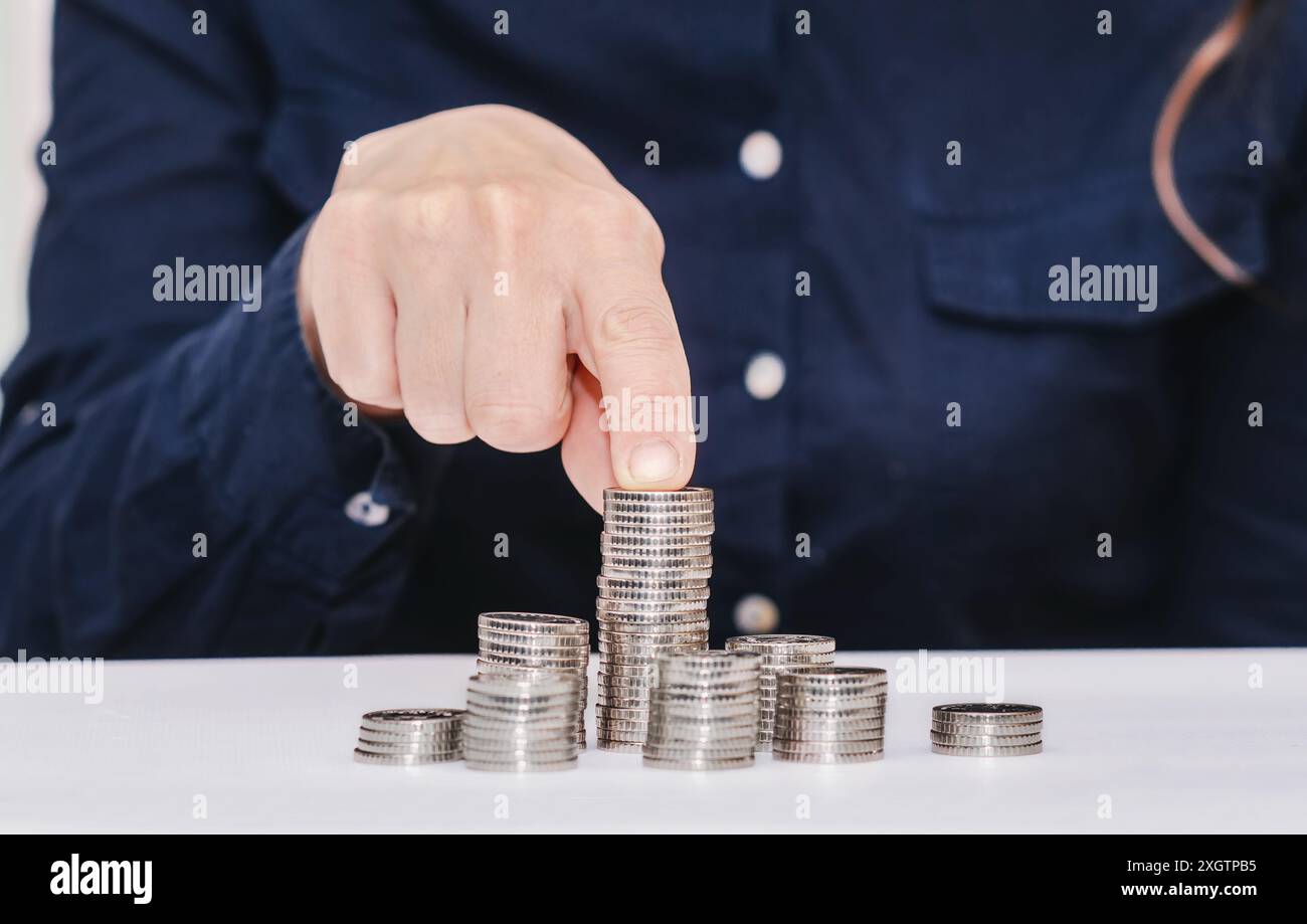 Woman holding coins stack hi-res stock photography and images - Alamy