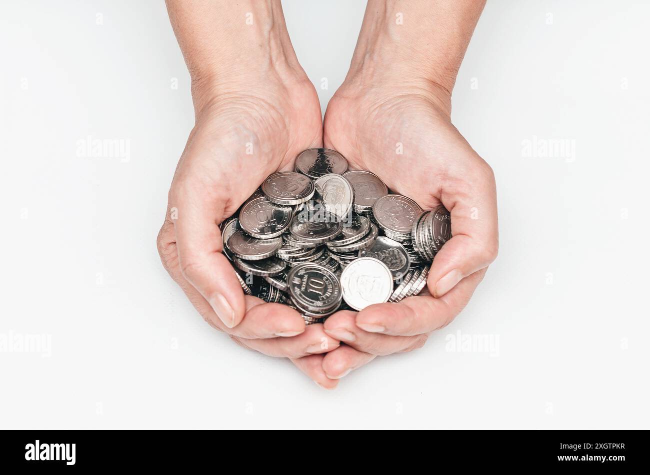 Female hands hold many silver coins in their palms Stock Photo - Alamy