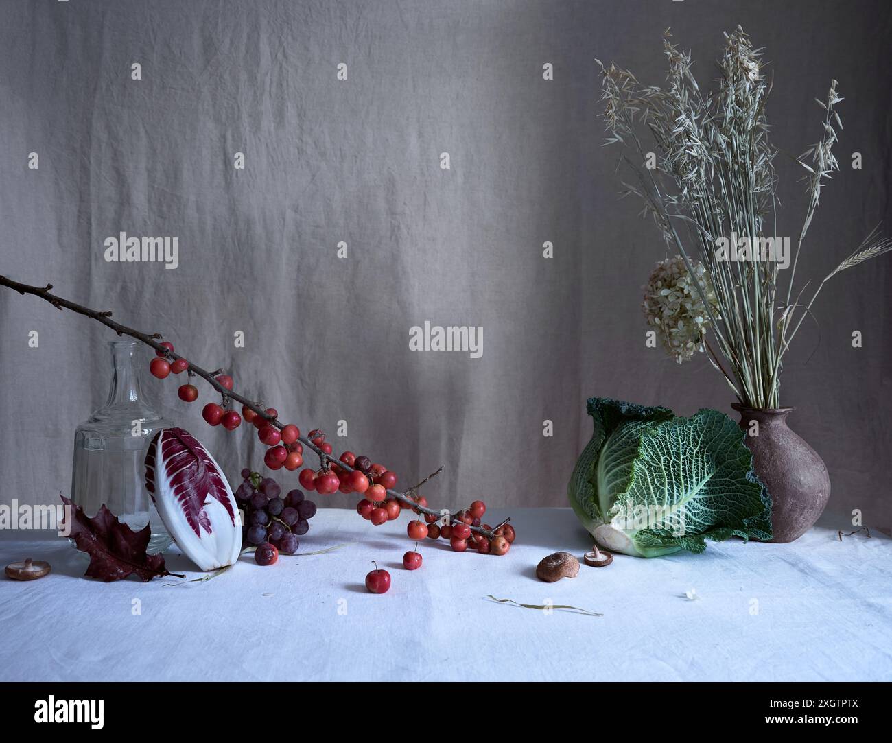 Artistic still life featuring tiny red crab apples, a split radicchio ...