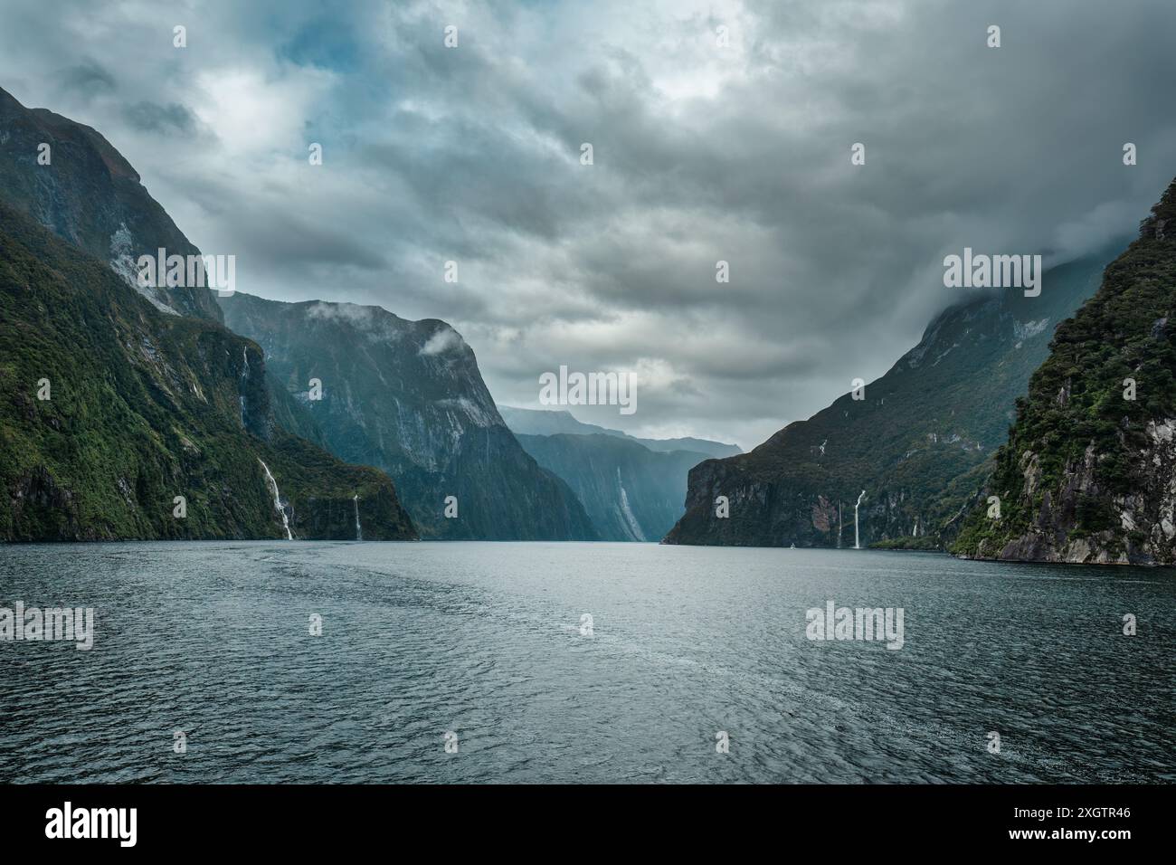 Cruise with majestic mountain and waterfall flowing in Fjord of Milford ...