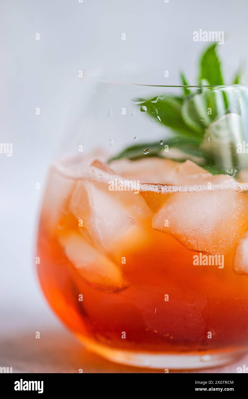 Close-up of a refreshing Coca-Cola cocktail with ice and fresh mint ...