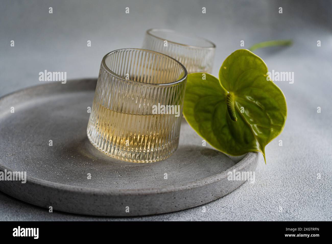 Elegant, minimalist table setting featuring a peach vodka cocktail in a ...