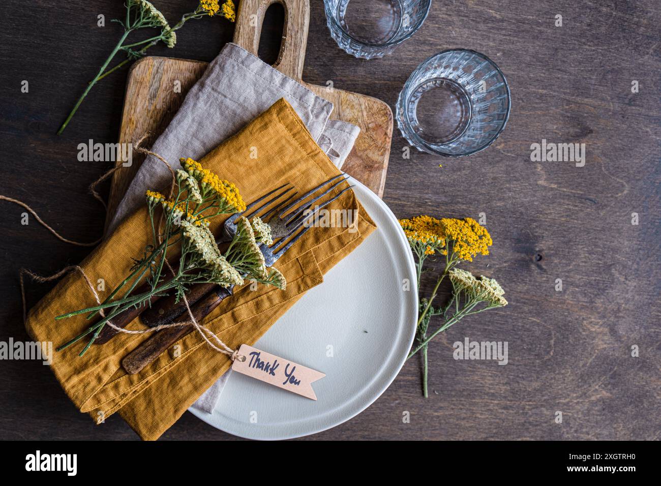 A cozy rustic table set with fresh Achillea wildflowers, complemented ...