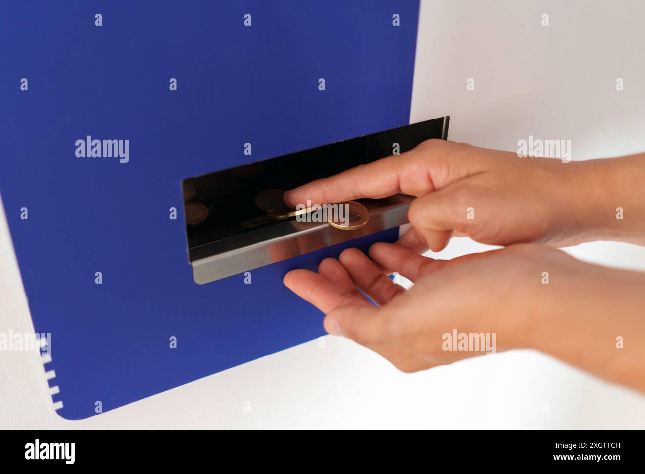 Woman's hands collecting coins from a cash exchange machine Stock Photo ...