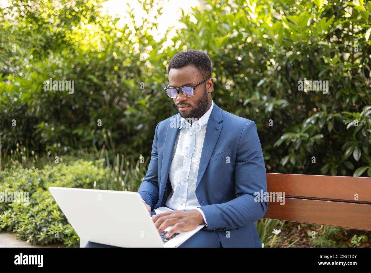 African American male professional dressed in a blue suit, working ...