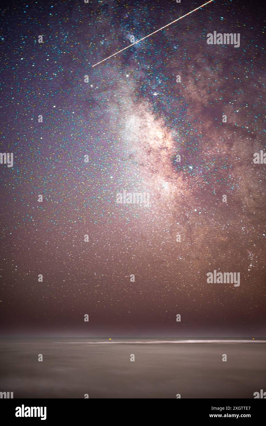 Starry night sky featuring the Milky Way over the calm Atlantic Ocean ...