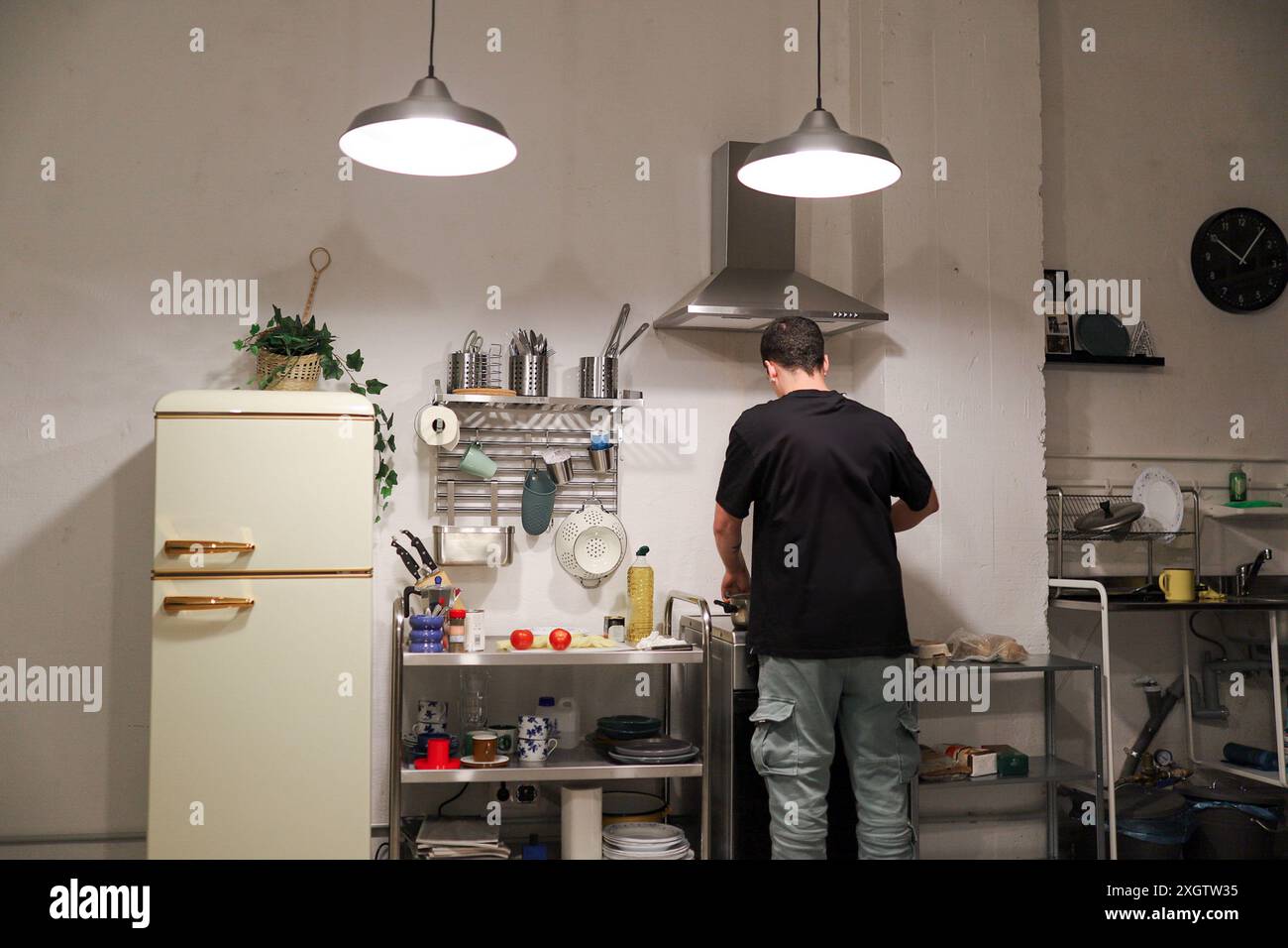 Back view of unrecognizable man preparing food in a modern, well ...
