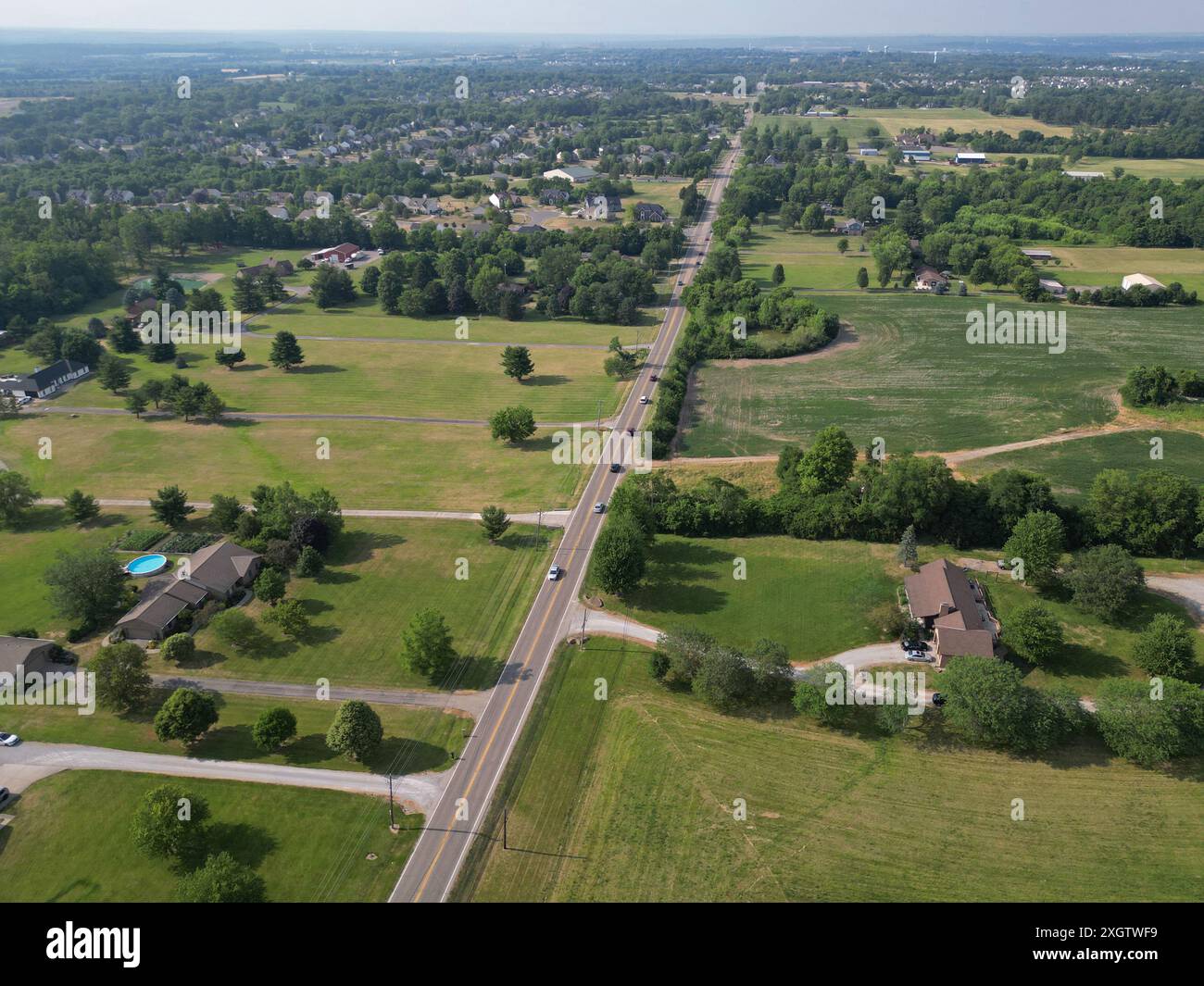 Rural homes with a suburban style neighborhood in the background are ...