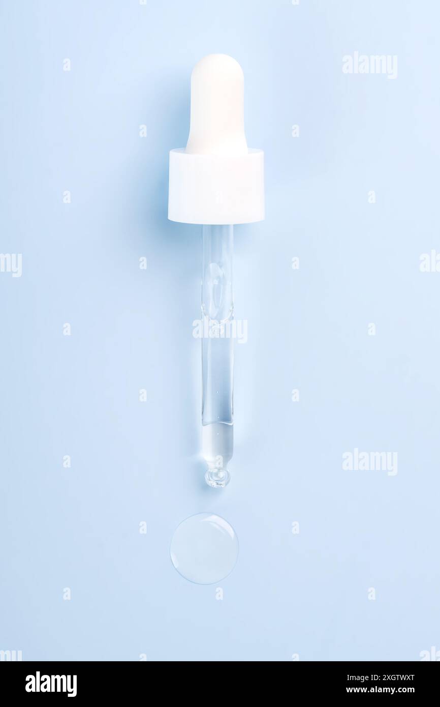 High angle shot of a transparent serum dropper with a single cosmetic ...