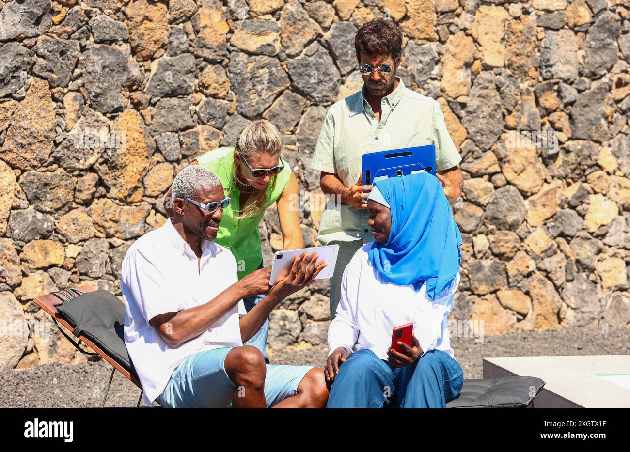 A multiracial business team in a summer setting, including African ...