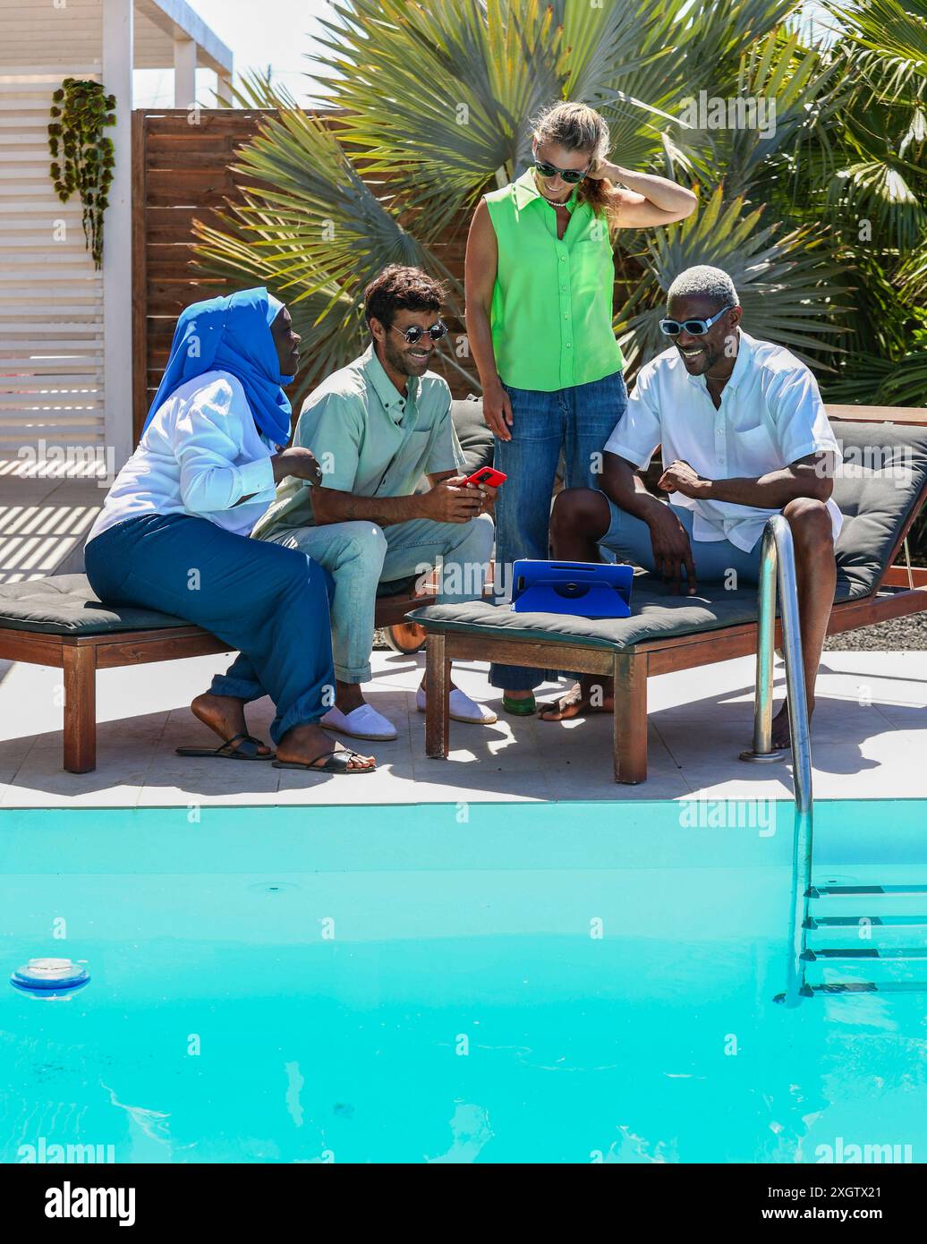 A diverse business group consisting of two African men, one South Asian ...