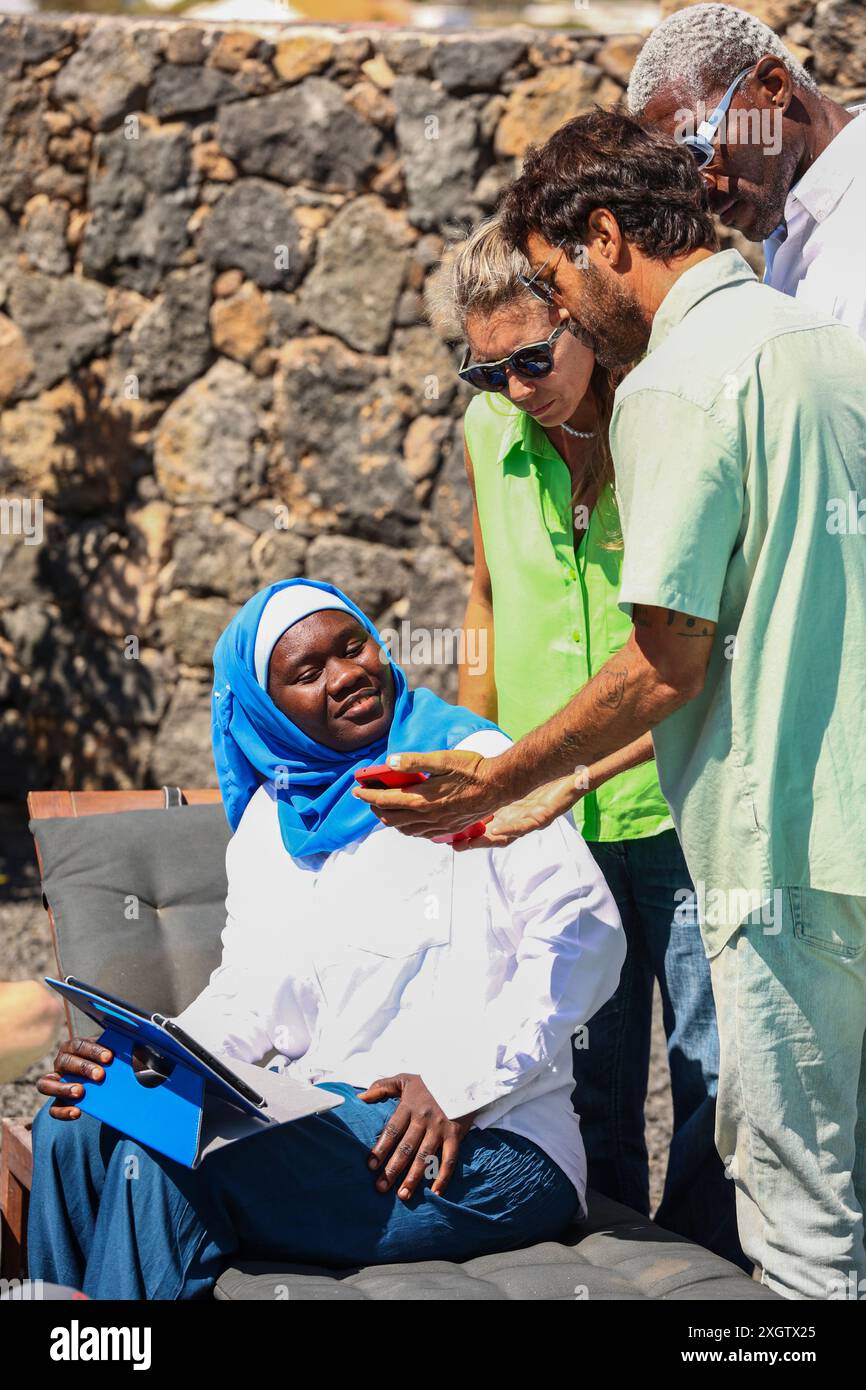 A diverse team engages in a summer business discussion outdoors. The ...