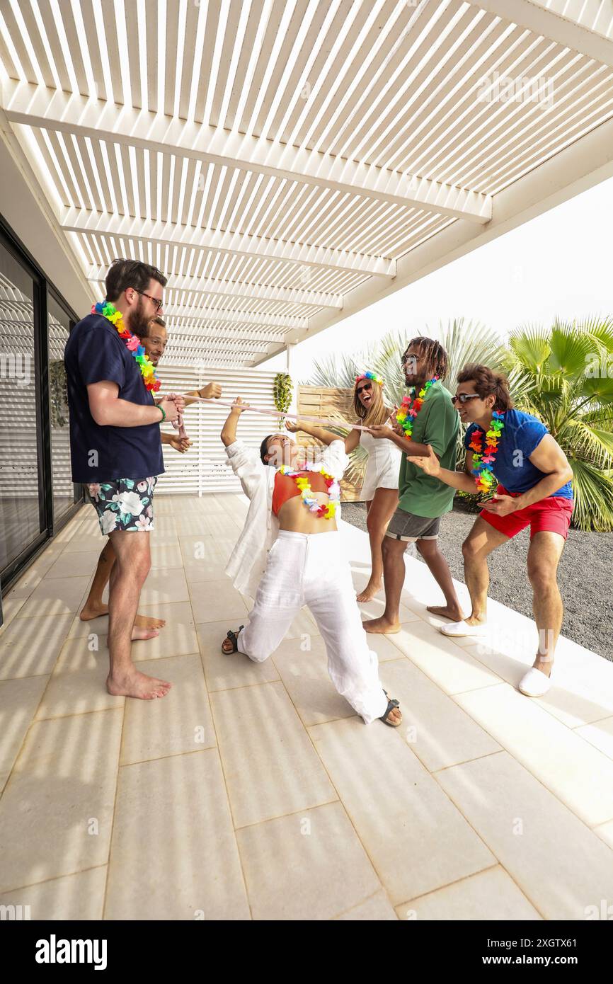 A diverse group of friends dances joyfully on a patio during a ...