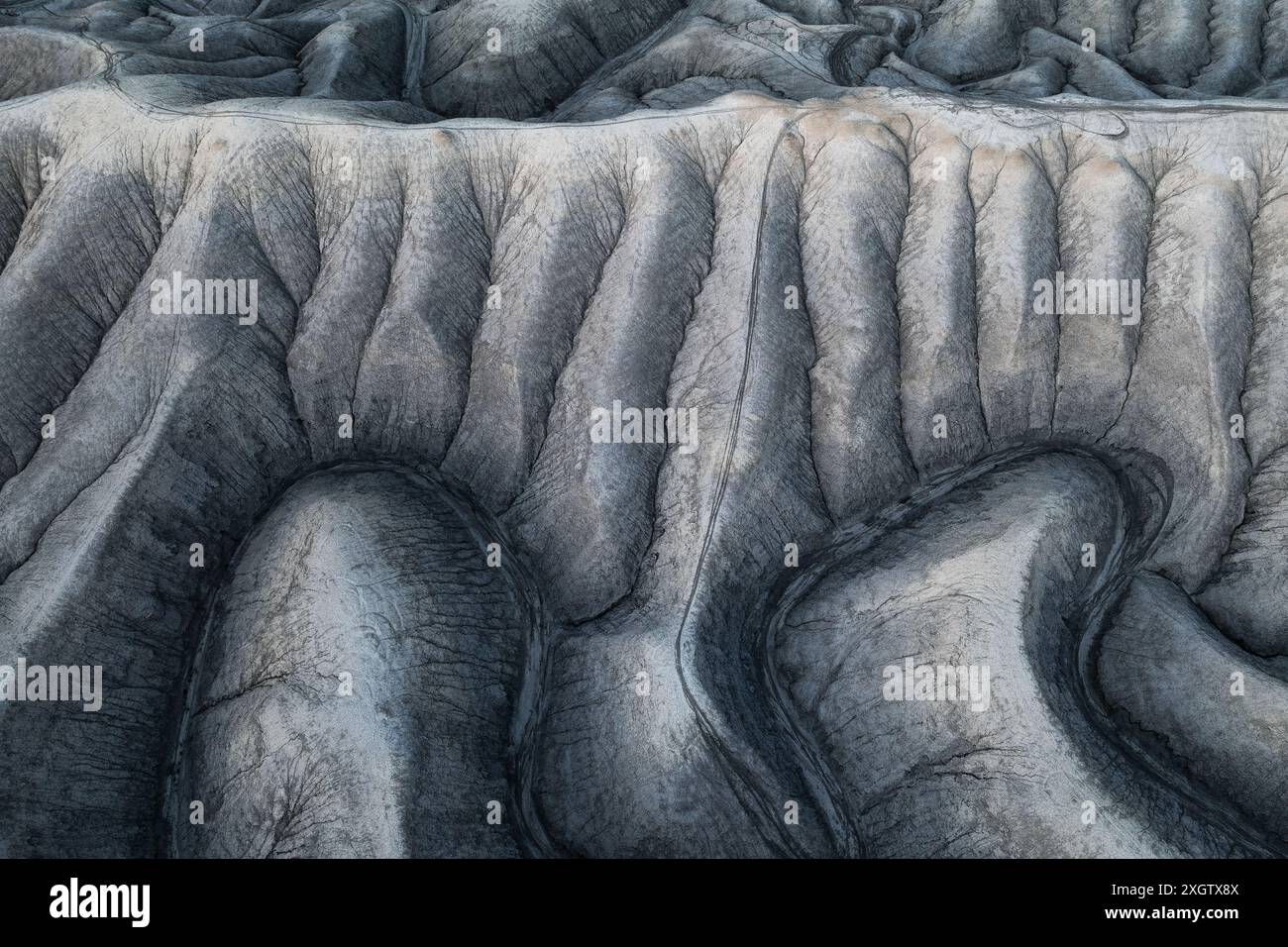 The eroded riverbed in Hanksville, Utah, displays dramatic, sinuous ...