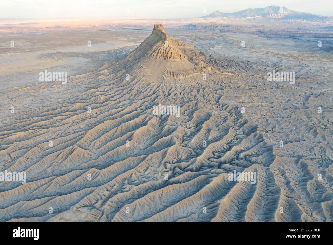 An aerial photograph captures the intricate, rippled terrain and rugged ...