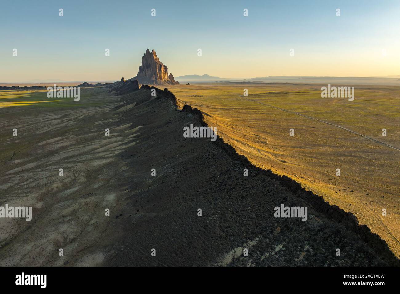 "An aerial view of Shiprock, a stunning rock formation at sunrise in the expansive desert of New ...
