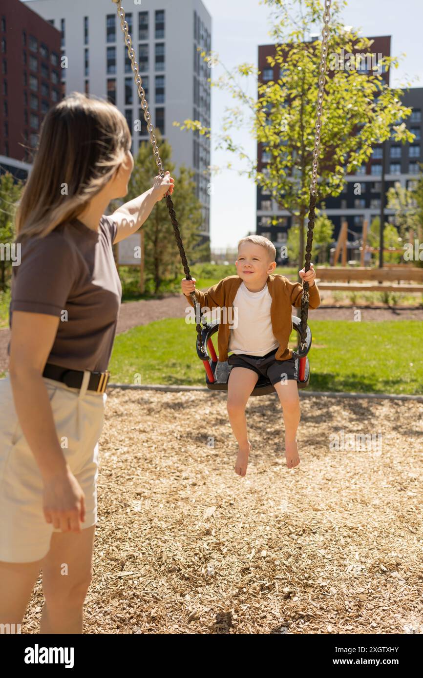 Child pushed on swing hi-res stock photography and images - Alamy