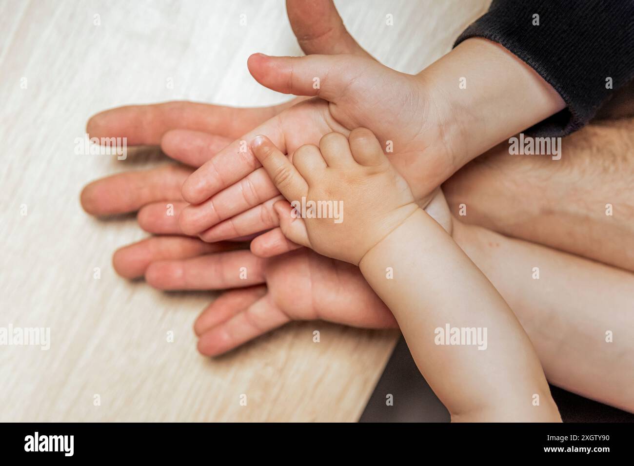Close-up image of anonymous various family members' hands together ...