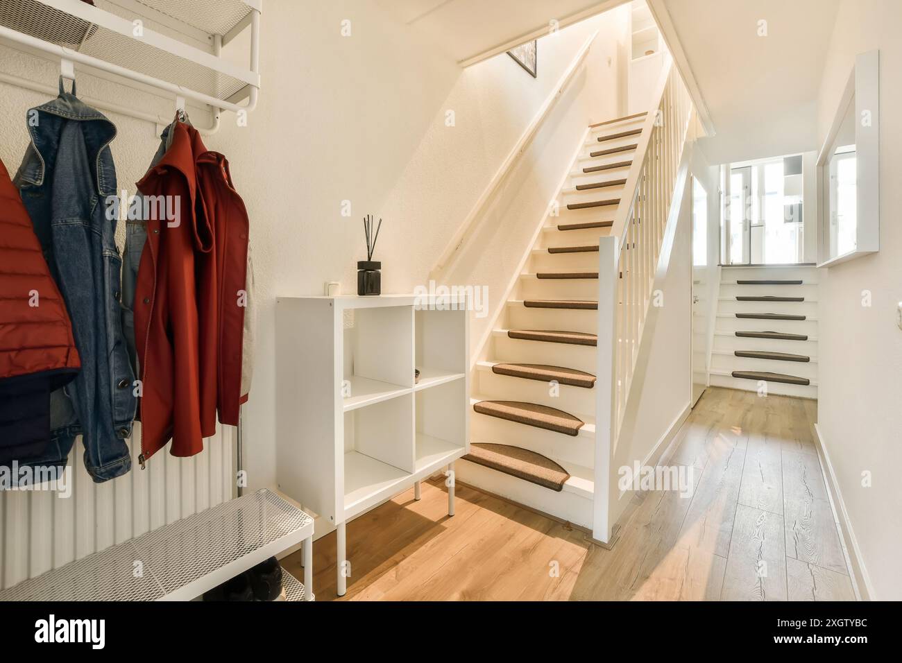 Bright and airy entryway showcasing a clean white interior with wooden ... Bright and airy entryway showcasing a clean white interior with wooden ...