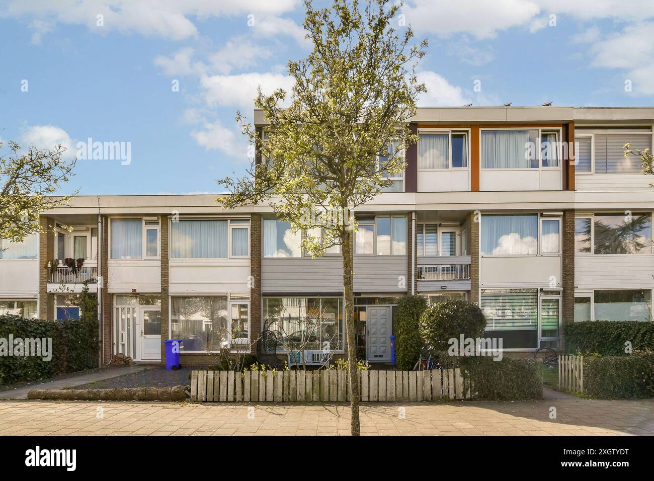 Modern row houses with a suburban feel, showcasing large windows and ...