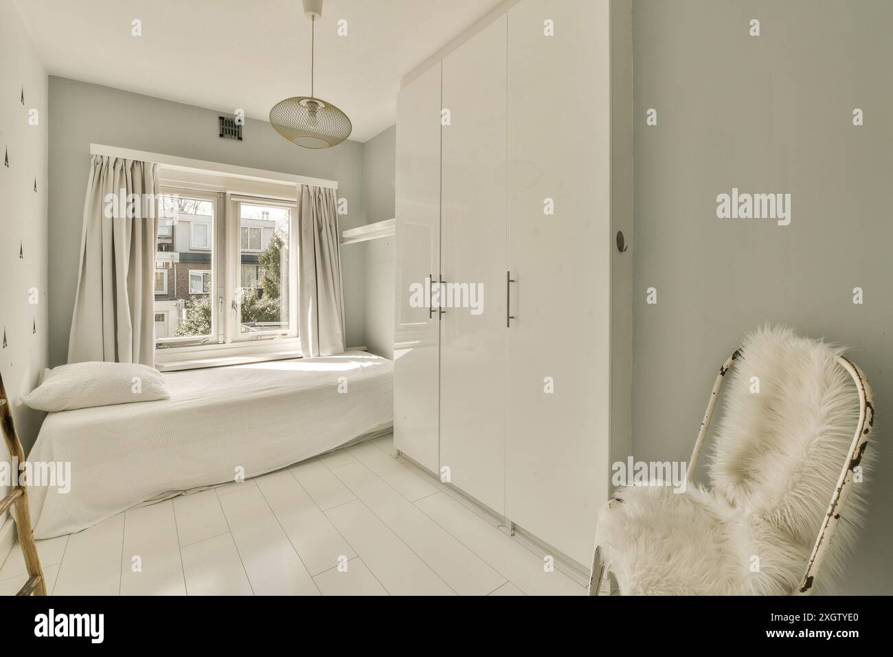 Airy minimalist bedroom featuring a white color palette, chic fur ...