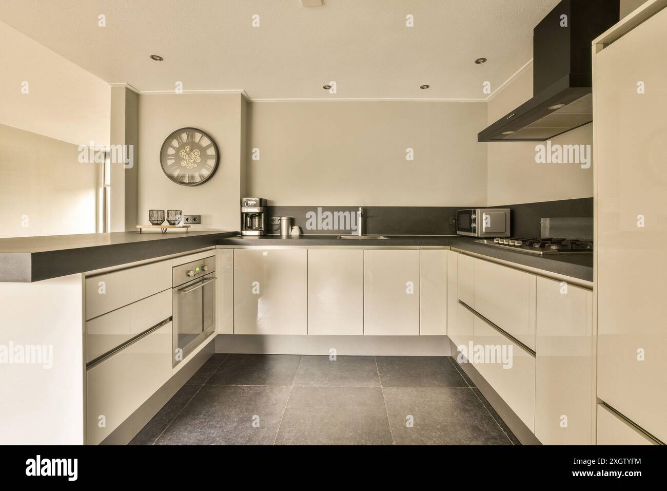 A contemporary kitchen featuring high-gloss cabinetry, built-in ...