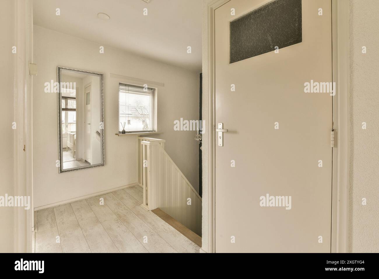 Bright and airy entrance hall with white walls, wooden flooring, a ...