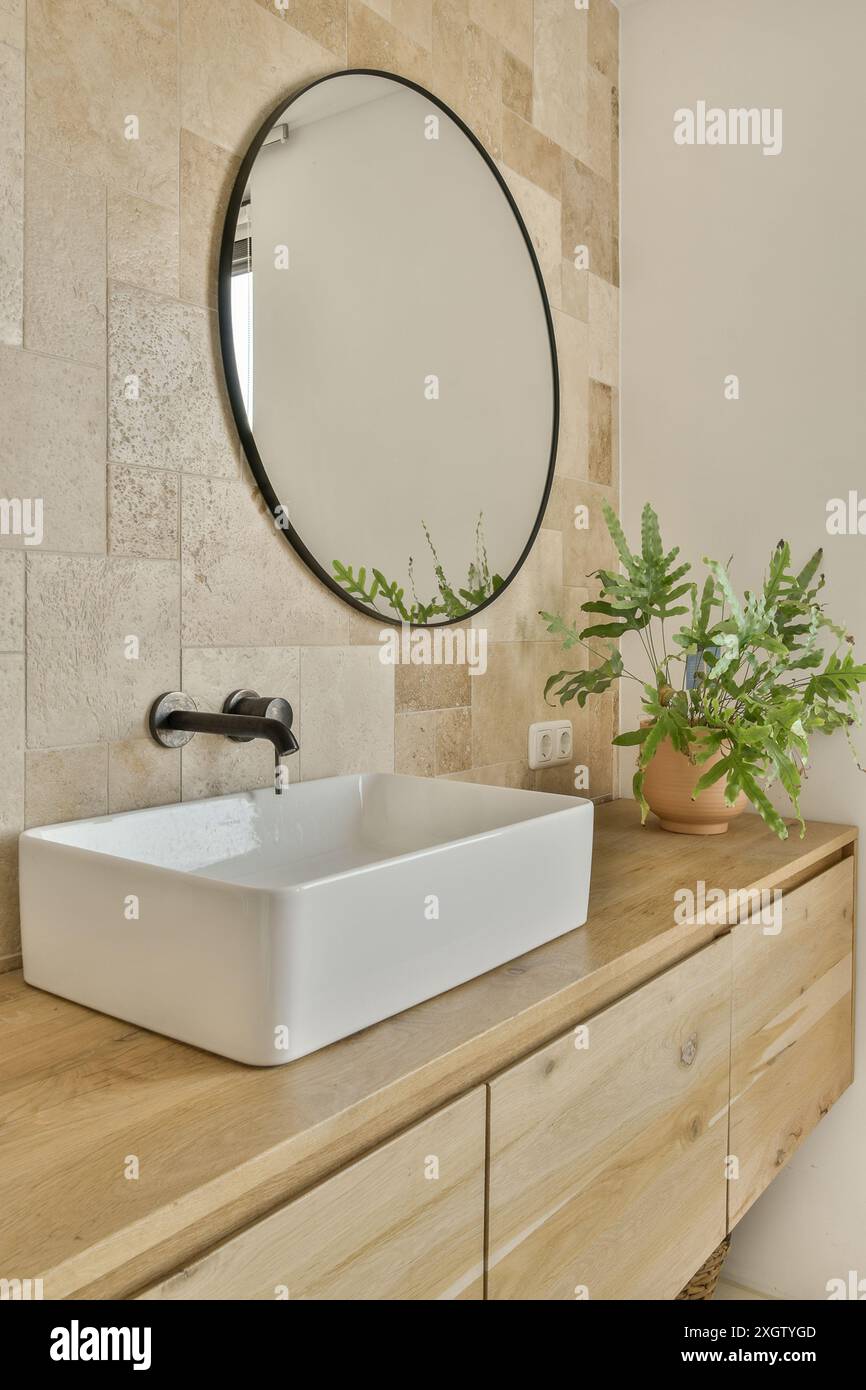This image features a stylish modern bathroom sink centered on a rustic ...