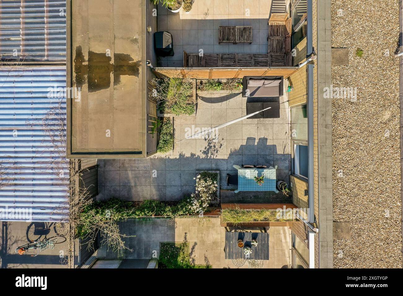 Overhead aerial shot captures a neatly organized urban backyard with ...