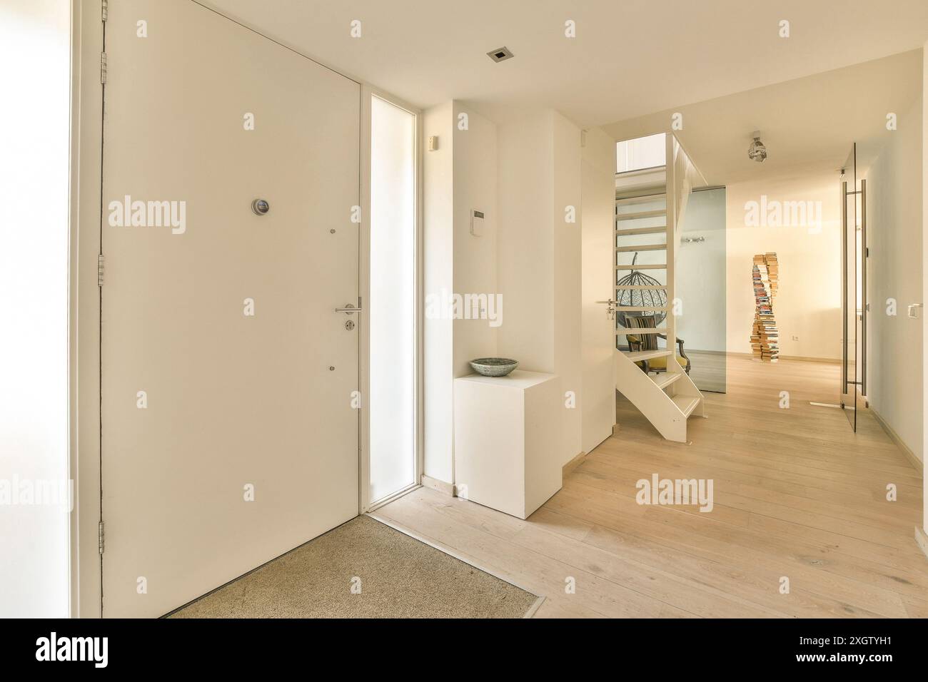 This bright and contemporary entryway features a minimalist design with ...