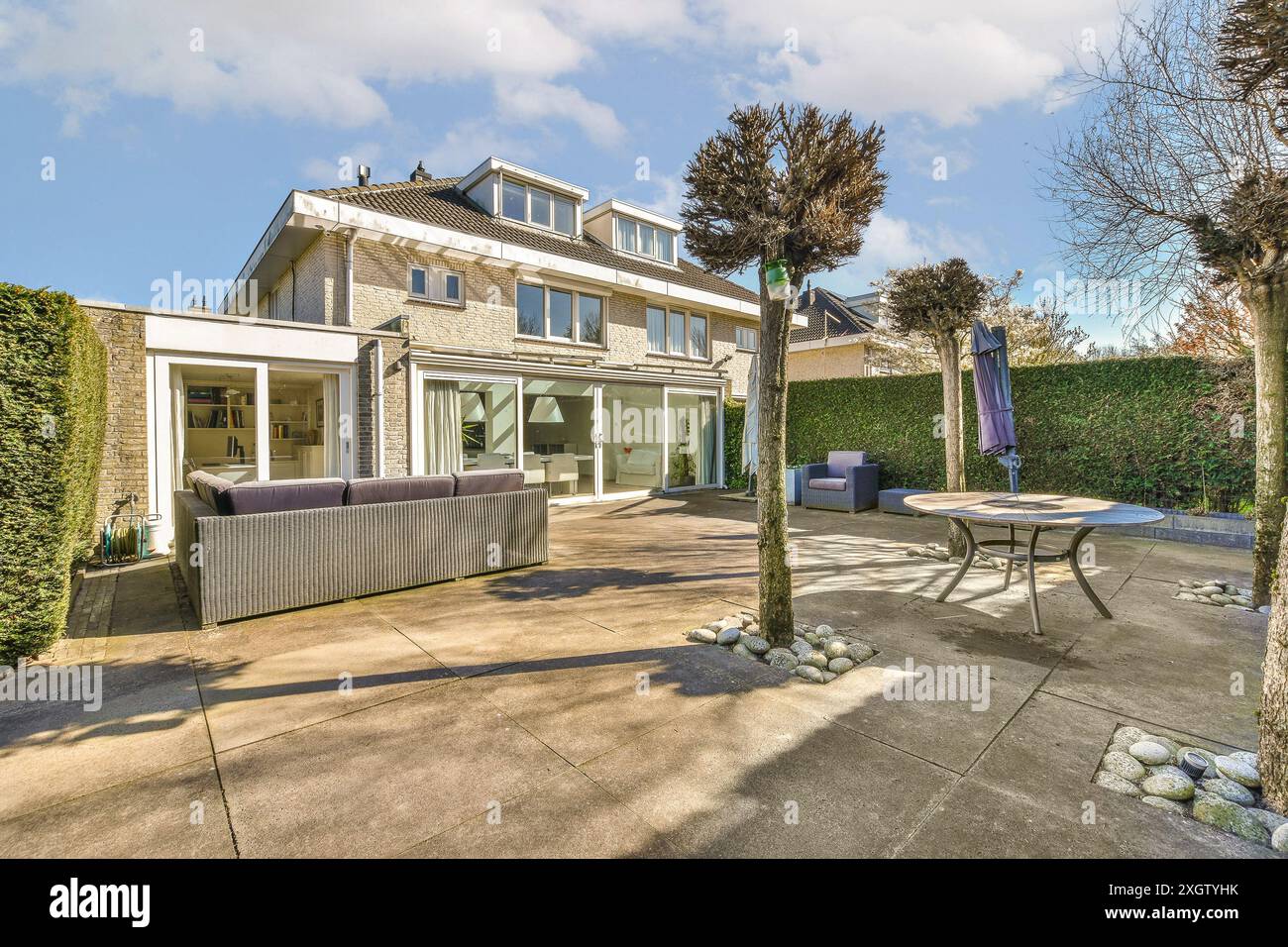 Contemporary luxury residence with brick walls and spacious outdoor ...