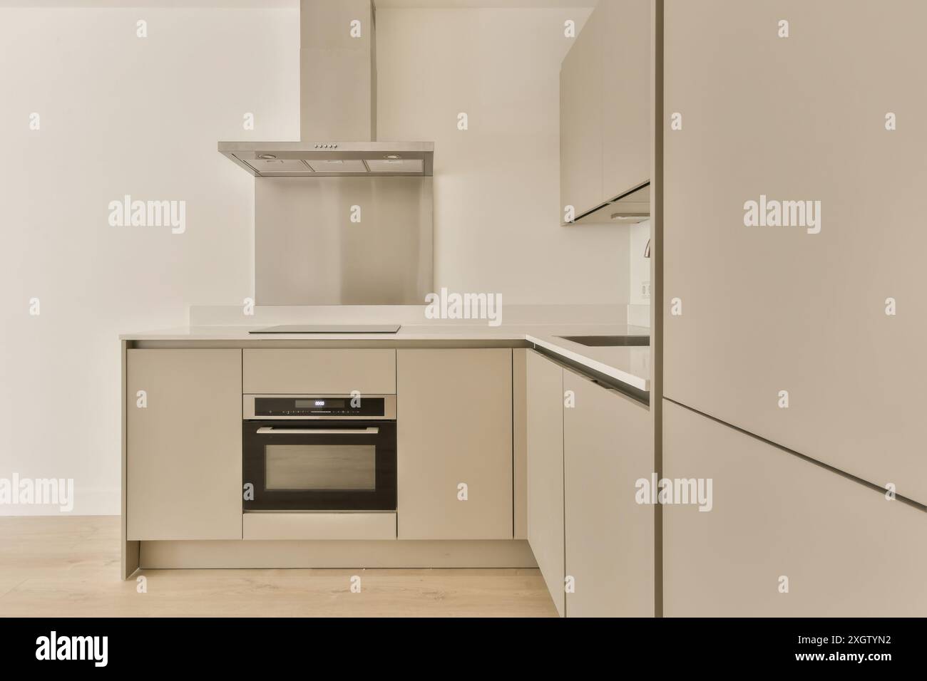 A contemporary kitchen interior featuring built-in appliances, clean ...