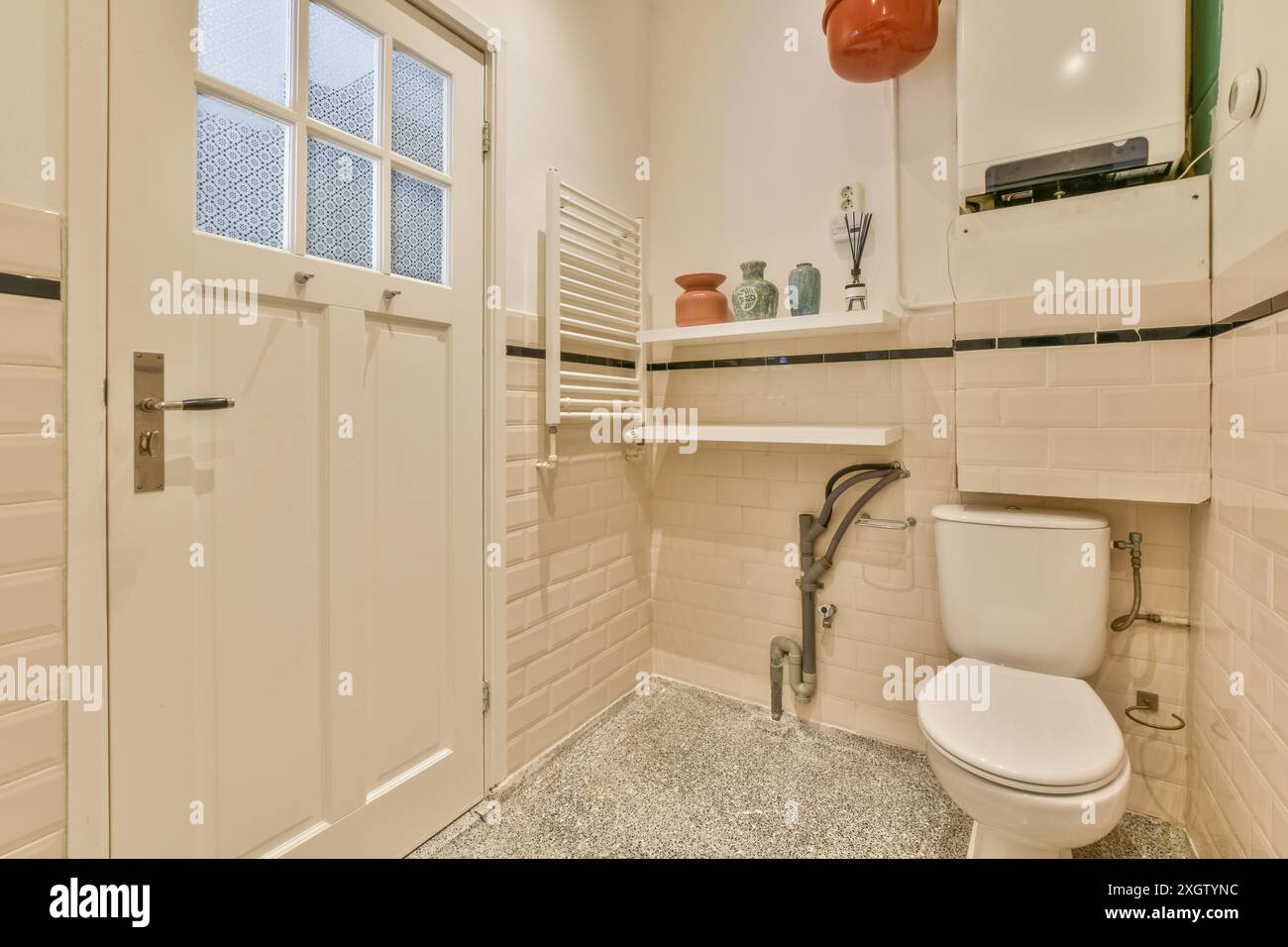 A cozy vintage-style bathroom featuring a classic white toilet, subway ...
