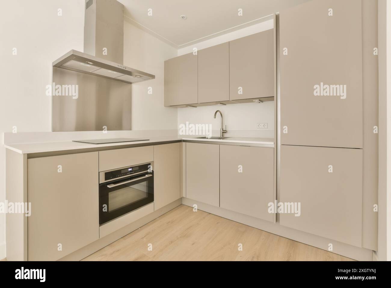 A sleek and contemporary kitchen featuring clean lines, neutral color ...