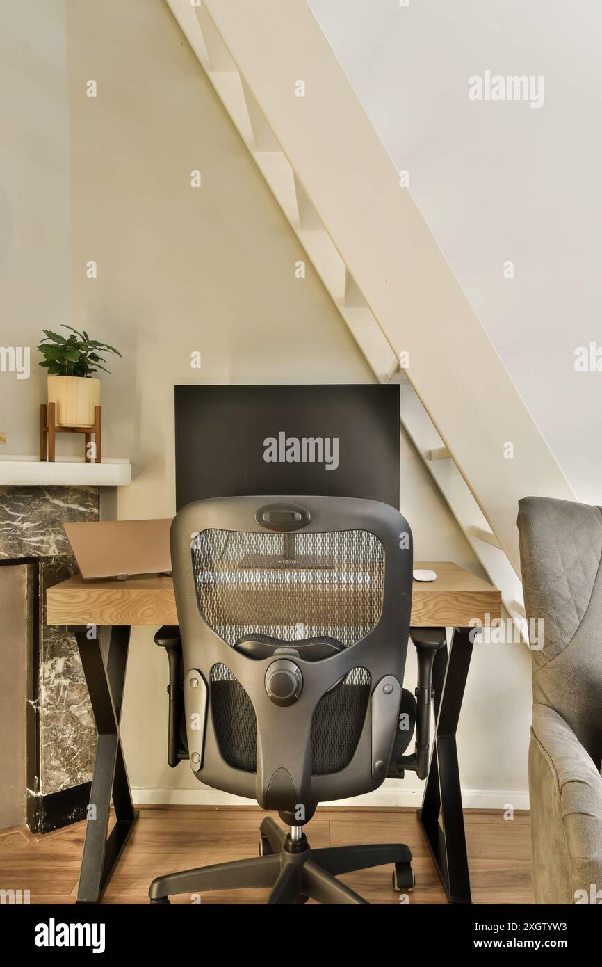 A cozy and stylish home office setup under a sloped ceiling, featuring ...