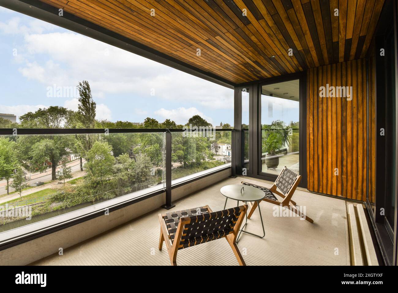 Contemporary balcony design showcasing wooden ceiling, two chairs, and ...
